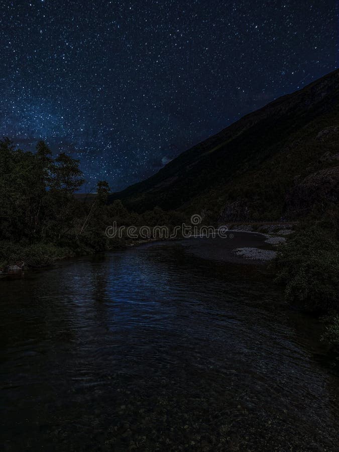 Vertical Shot a River and a Mountainside Under the Blue Starry Sky at ...