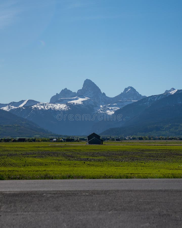 Vertical Shot of Road, Empty Grass Plain and Mountain Range in the ...
