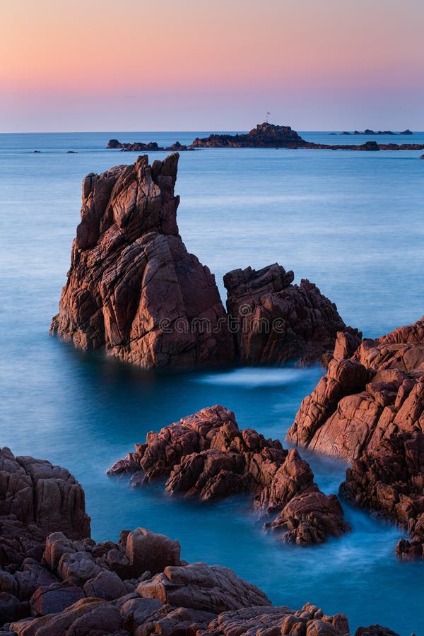 Vertical Shot of Rock Formations in the Beautiful Clear Blue Sea in ...