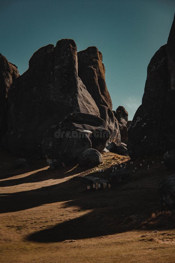 Vertical Shot of Rock Formations on Grass with Big Shadows Stock Image ...