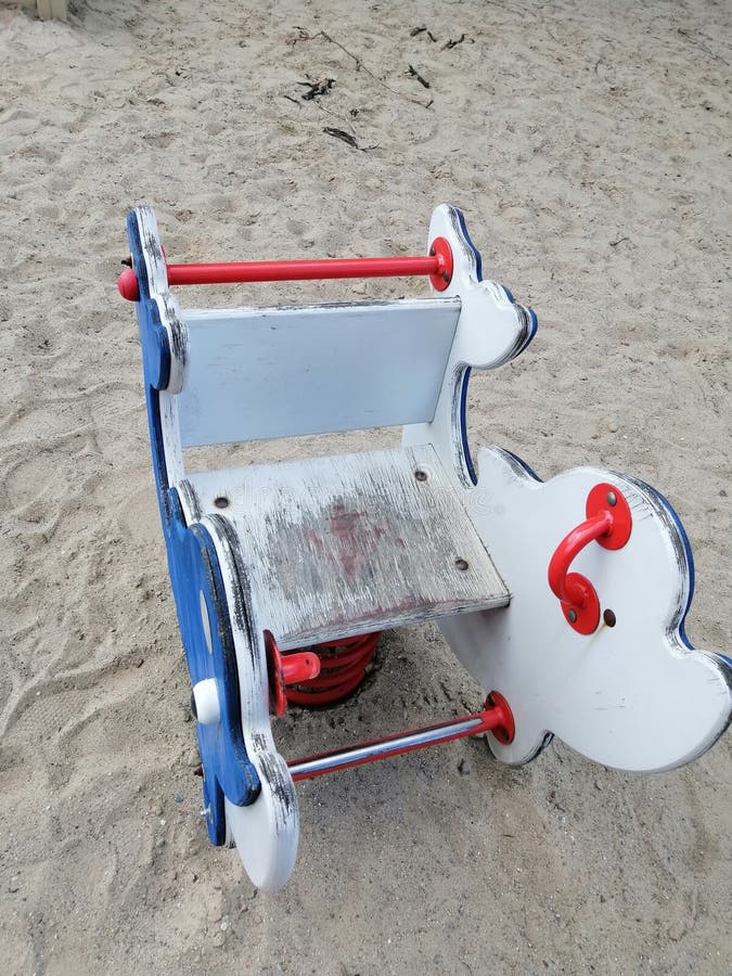 Vertical Shot of a Rocking Chair on the Sand at the Playground Stock ...