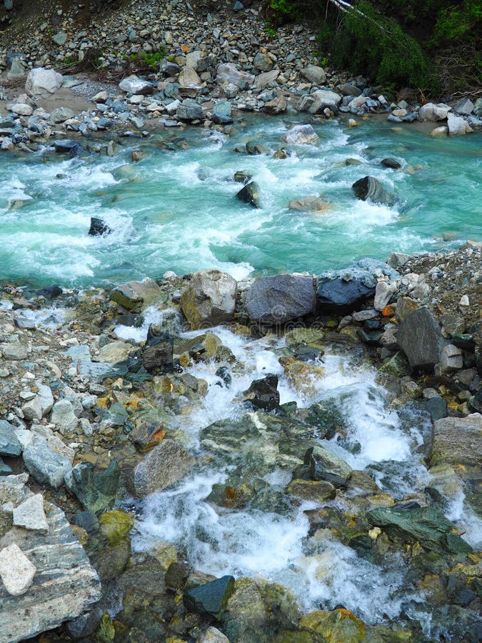 Vertical Shot of Rocks in a Stream Flowing Water Stock Image - Image of ...
