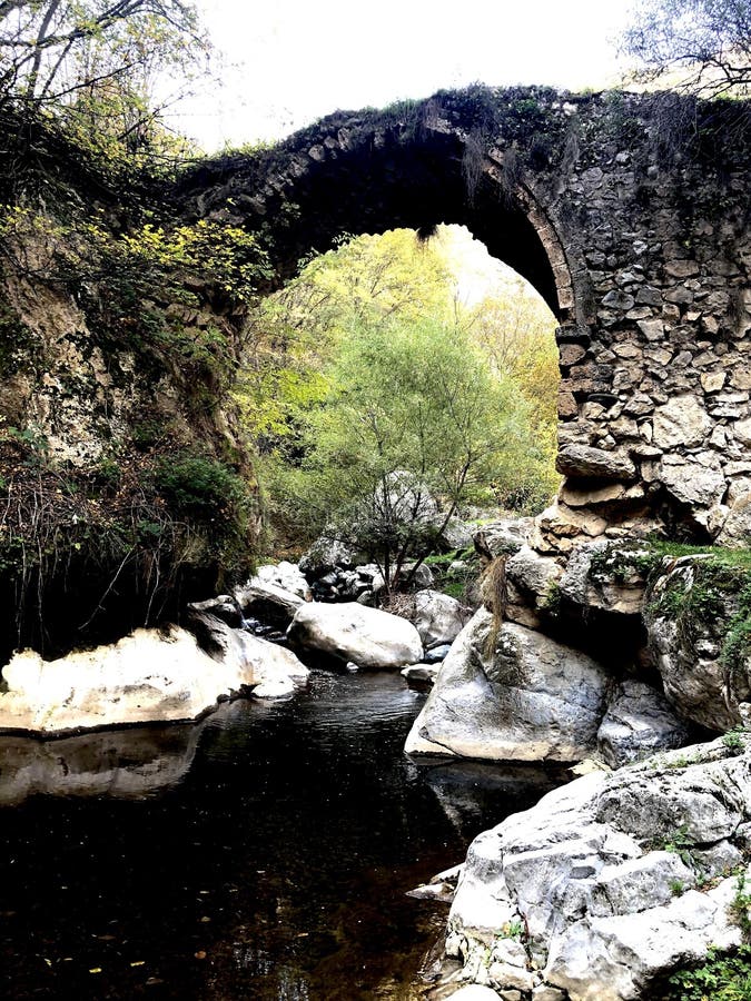 Vertical Shot of a Rocky Arch Over the River in the Forest Stock Image ...