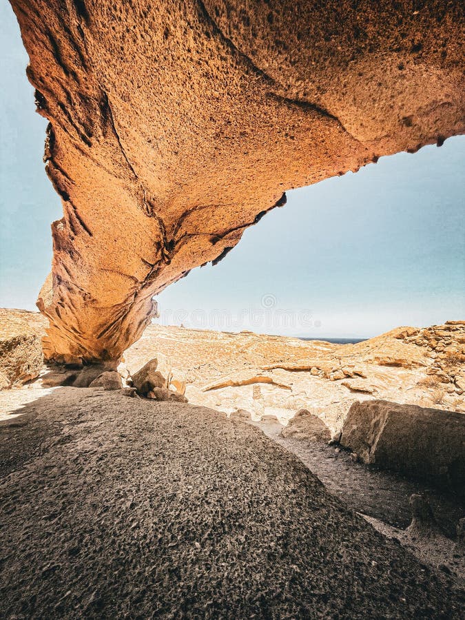 Vertical Shot of a Rocky Cliff on the Beach Stock Photo - Image of sand ...