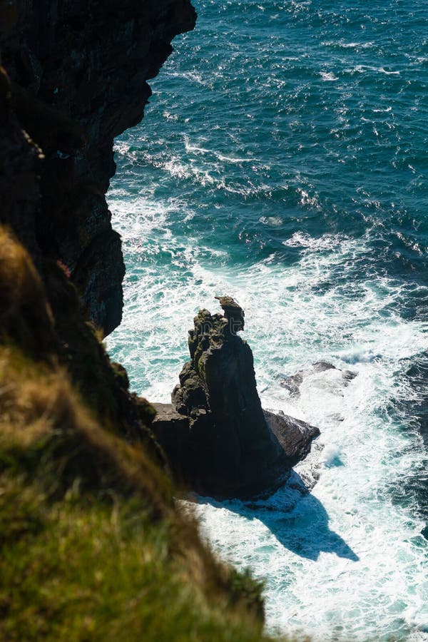 Vertical Shot of the Rocky Cliff and the Sea Stock Image - Image of ...