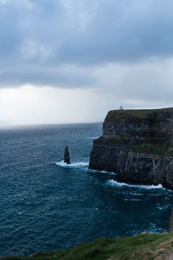 Vertical Shot of the Rocky Cliff and the Sea Stock Image - Image of ...