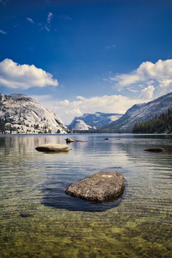 Vertical Shot of a Rocky Lake between Mountains Stock Photo - Image of ...