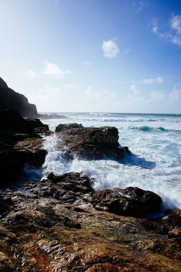 Vertical Shot of a Rocky Shore with Ocean Waves Stock Image - Image of ...