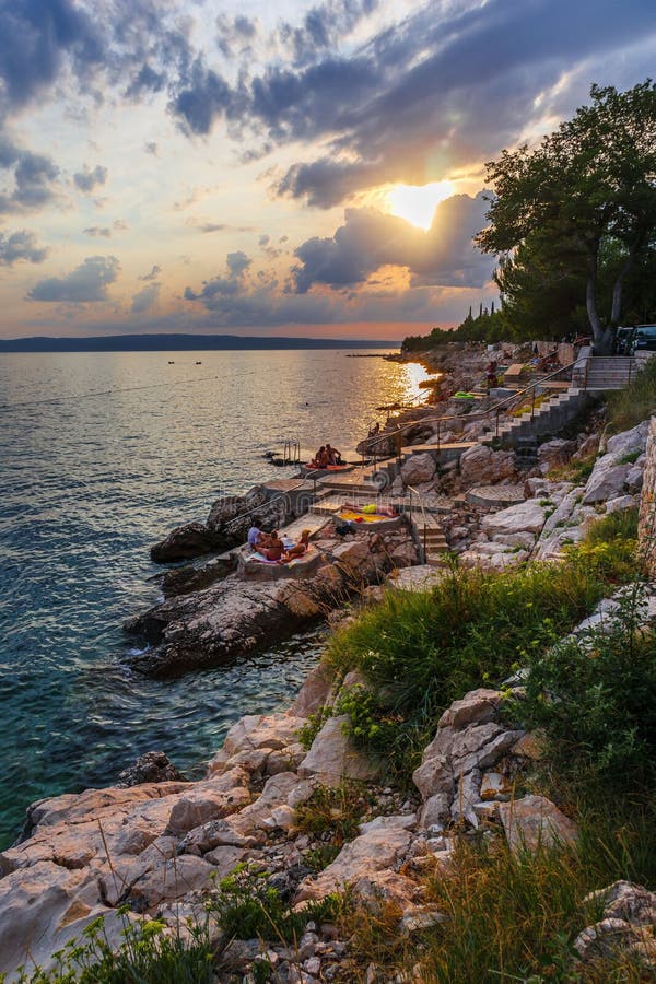 Vertical Shot of a Rocky Shoreline of a Lake Seen during the Sunset ...