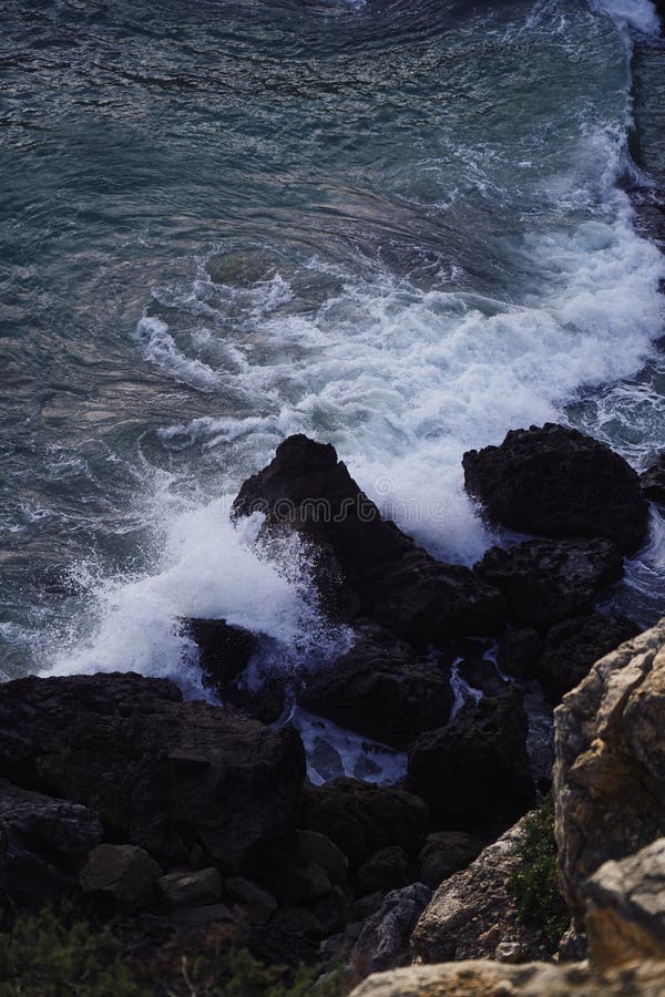 Vertical Shot of a Rogue Waves Crashing into Cliffs Stock Photo - Image ...