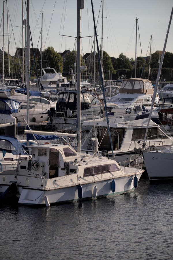 Vertical Shot of Row of Empty Docked Boats at Chatham Harbor in the UK ...