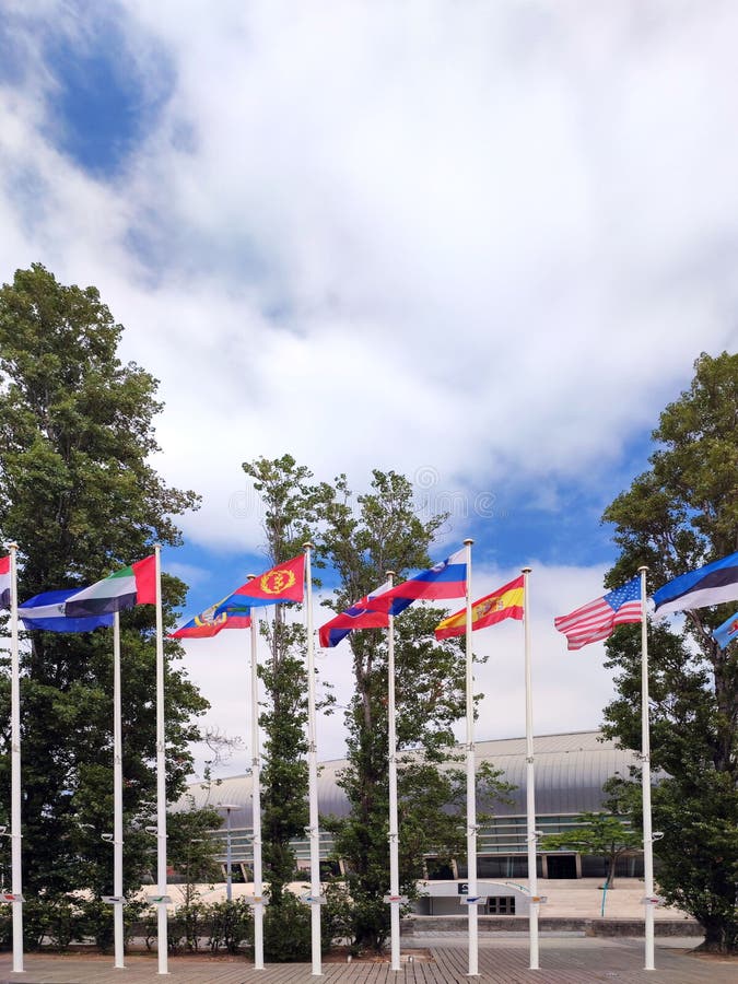 Vertical Shot of a Row of Flags of Different Countries on White Pols ...