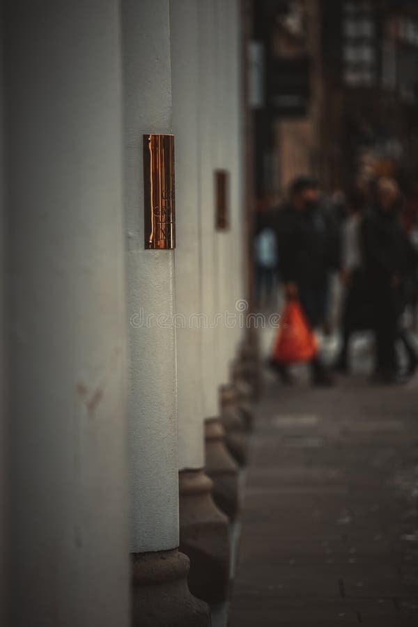 Vertical Shot of the Row of White Columns with a Golden Tile. Selected ...