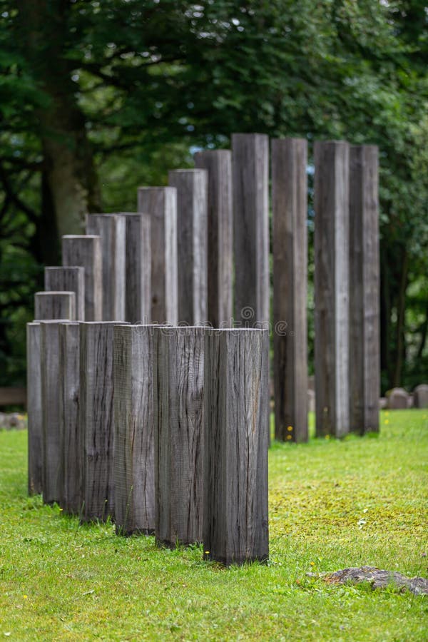 Vertical Shot of a Row of Wooden Posts with Increasing Heights in a ...