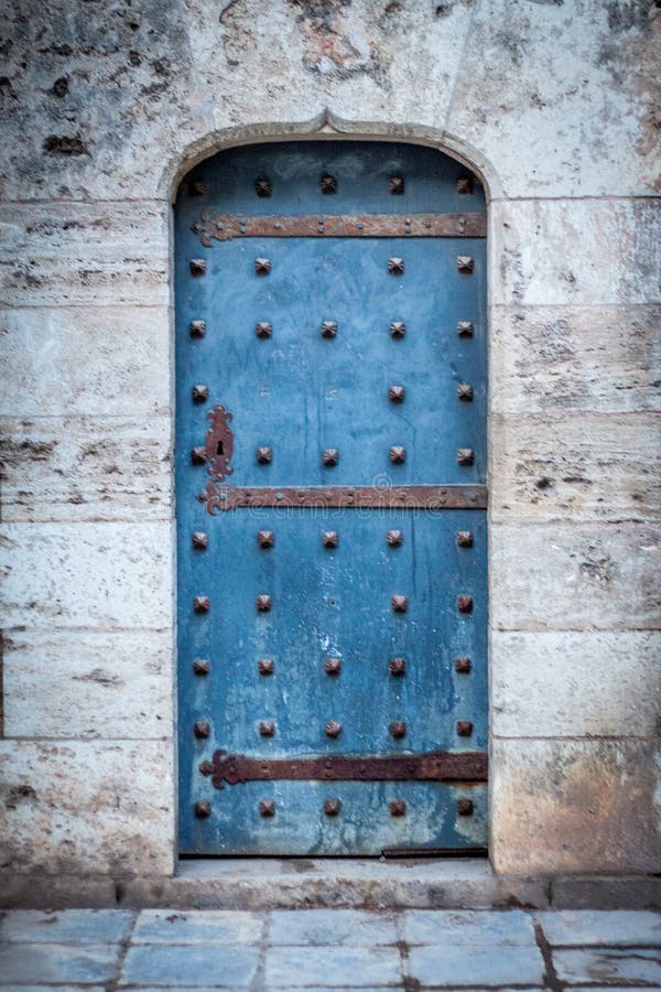 Vertical Shot of a Rusty Blue Door on a Wooden Exterior Wall Stock ...