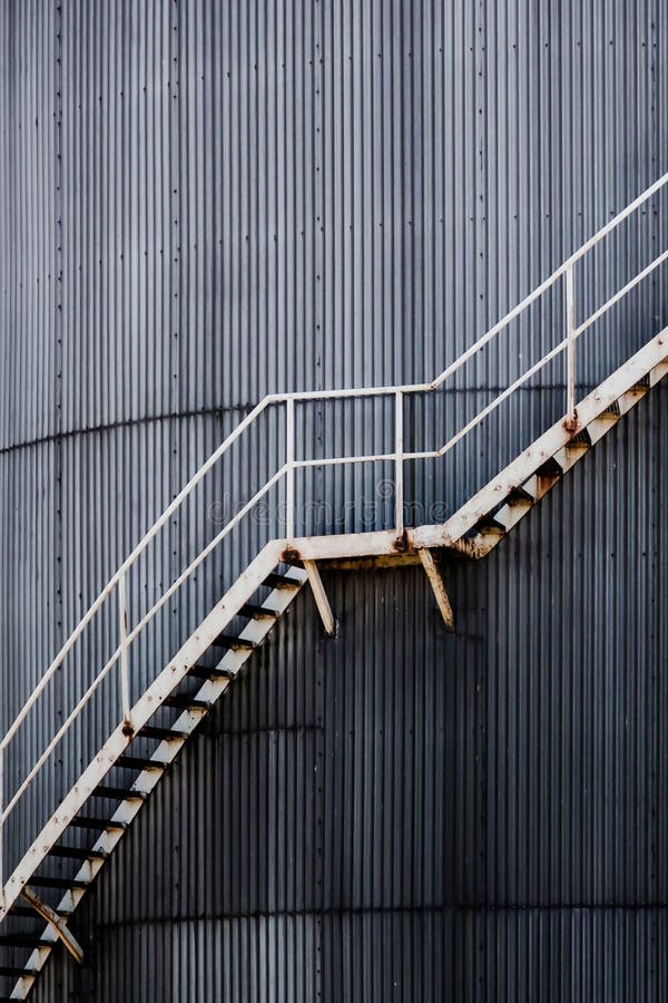 Vertical Shot of Rusty Metal Stairs on the Side of a Metal Building ...