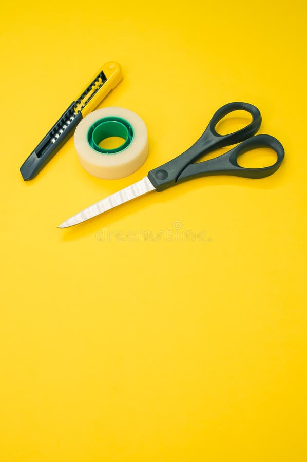 Vertical Shot of Scissors Adhesive Tape and a Utility Knife Stock Image ...