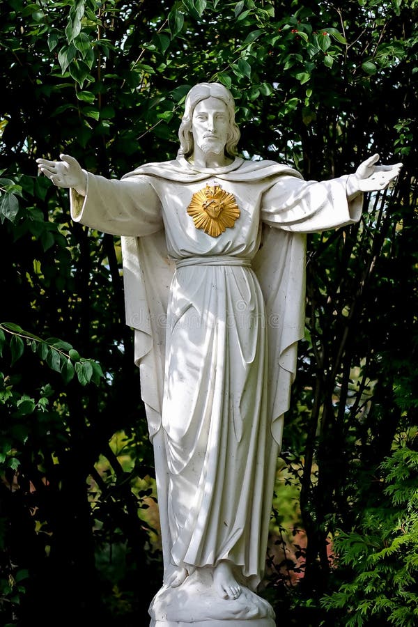 Vertical Shot of the Sculpture of Jesus Christ Surrounded by Trees ...