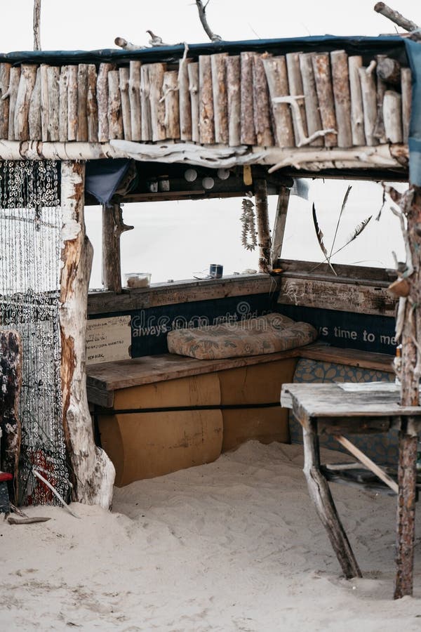Vertical Shot of a Shack Made of Tree Trunks and Logs on a Beach with ...