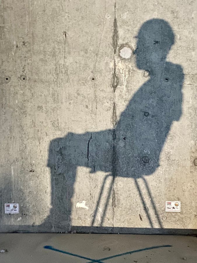 Vertical Shot of a Shadow of a Construction Worker Sitting on a Chair ...