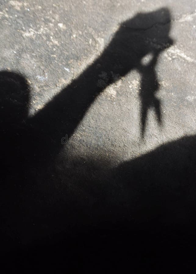 Vertical Shot of a Shadow of a Hand Holding Scissors on a Wall Stock ...