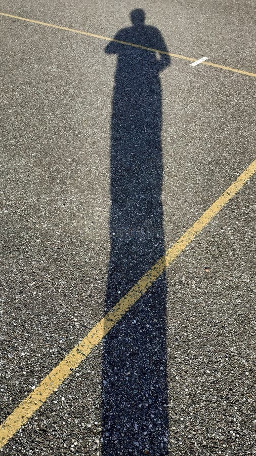 Shadow of a Person Standing on the Ground Pointing at a Particular ...