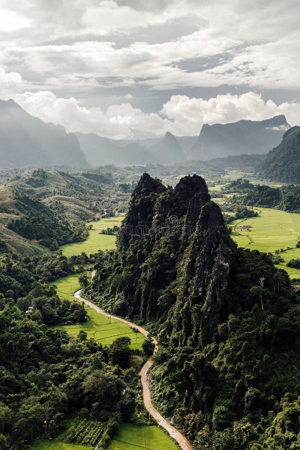 Vertical Shot of a Sharp Hill Covered with Trees and a Path beside it ...