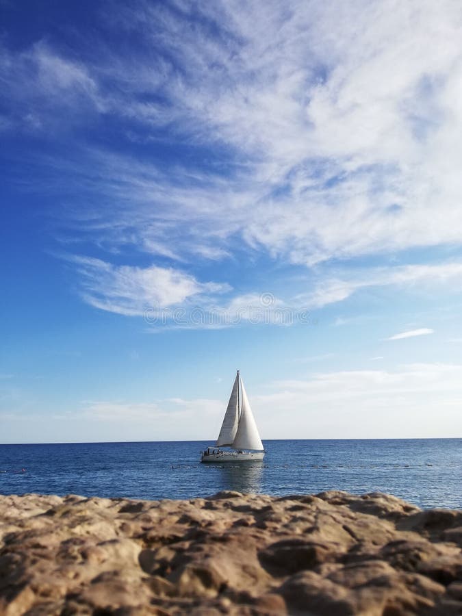 Vertical Shot of a Ship Sailing Near the Rocky Coast Stock Photo ...