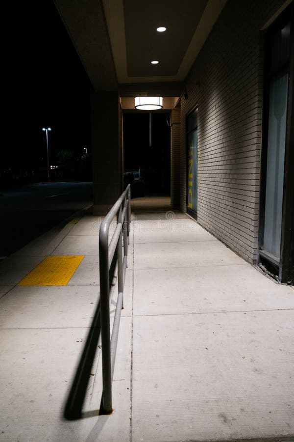 Vertical Shot of a Sidewalk and a Guardrail during Nighttime Stock ...