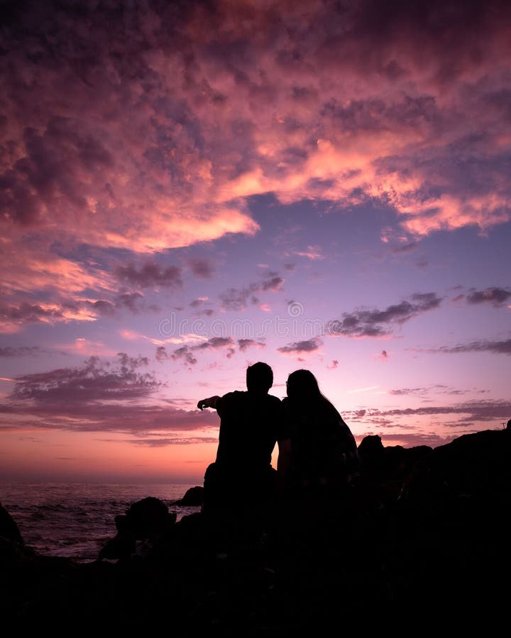 Vertical Shot of a Silhouette of a Couple Looking at an Ocean View at ...