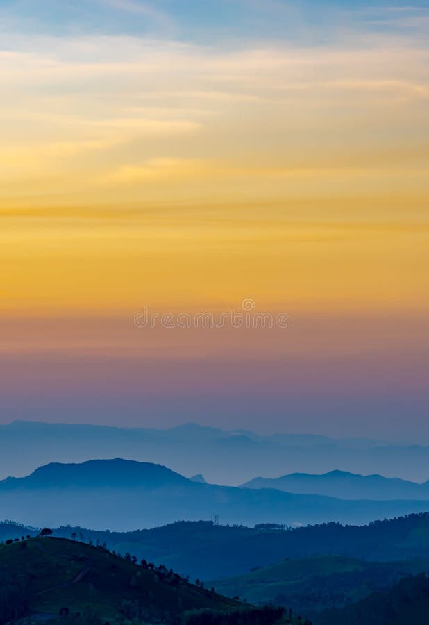 Vertical Shot of a Silhouette of Mountains during Sunset with Pinkish ...
