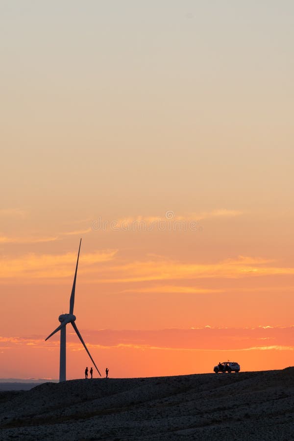 Vertical Shot of a Silhouette of a Windmill on a Grass Field in a ...