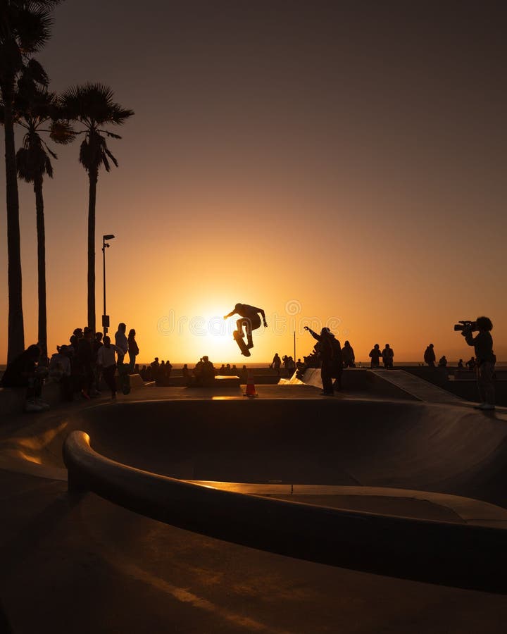 Vertical Shot of the Silhouettes of the People in the Skate Park with a ...
