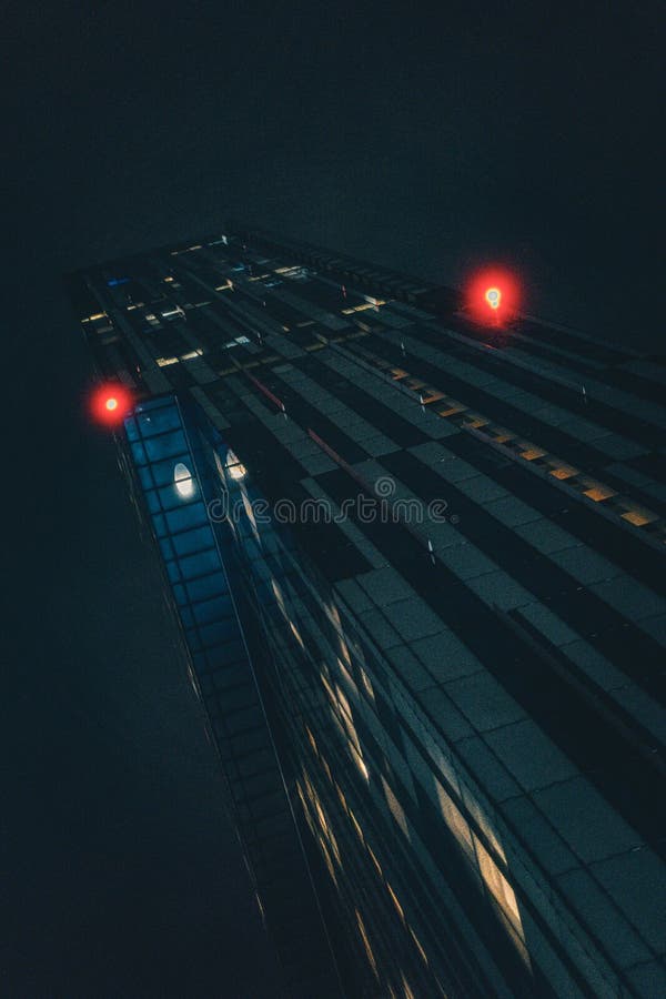 Vertical Shot of a Skyscraper Illuminated by Lights at Night Stock ...