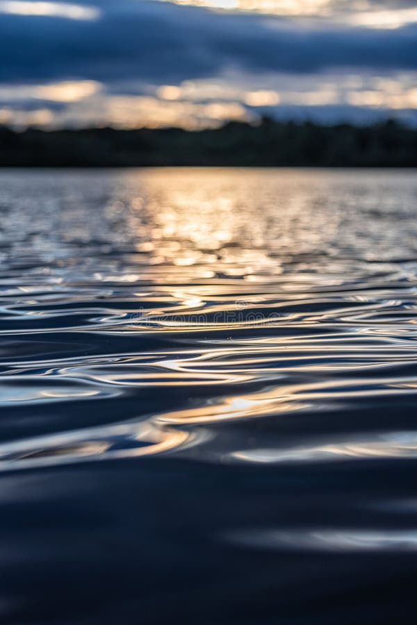 Vertical Shot of Smooth and Calm Water Ripples with the Sunset ...