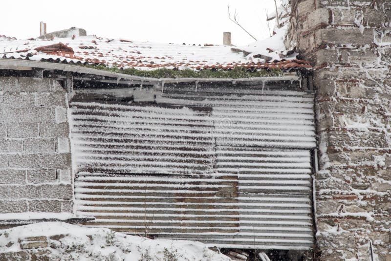 Vertical Shot of a Snow-covered Hut with a Broken Gate in Winter Stock ...