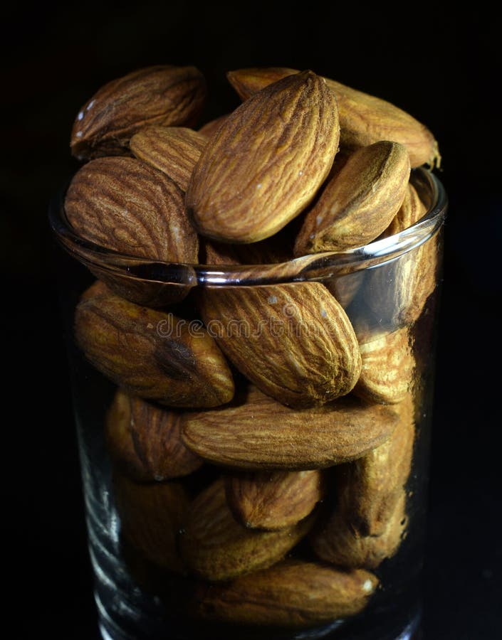 Vertical Shot of Some Almonds in a Small Glass Stock Photo - Image of ...