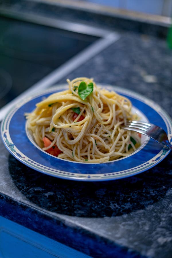 Vertical Shot of Spaghetti Pasta in a Blue Plate Stock Photo - Image of ...
