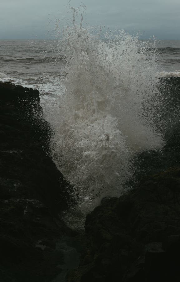 Vertical Shot of Splash of Sea Water Waves Hitting the Rocky Beach ...