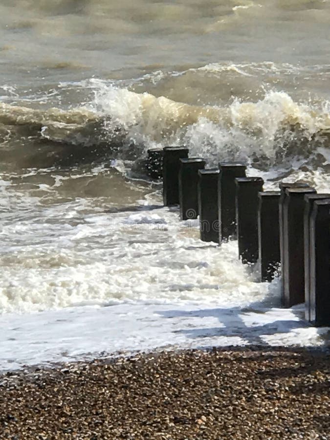 Vertical Shot of the Splashing Waves of the Sea with a Barrier Stock ...