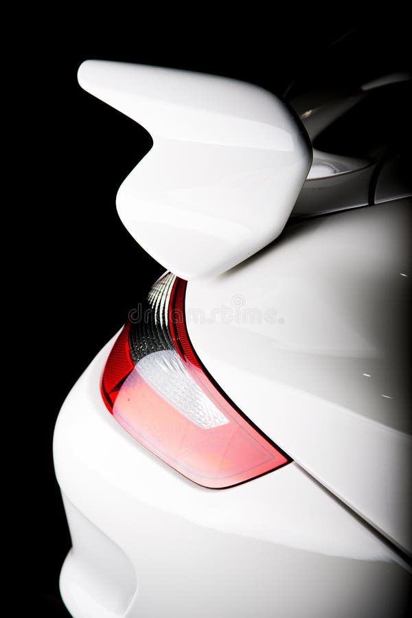 Vertical Shot of a Spoiler on a White Luxury Car Under the Lights ...