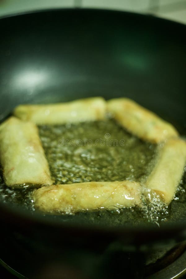 Vertical Shot of Spring Rolls Frying in a Pan Stock Photo - Image of ...