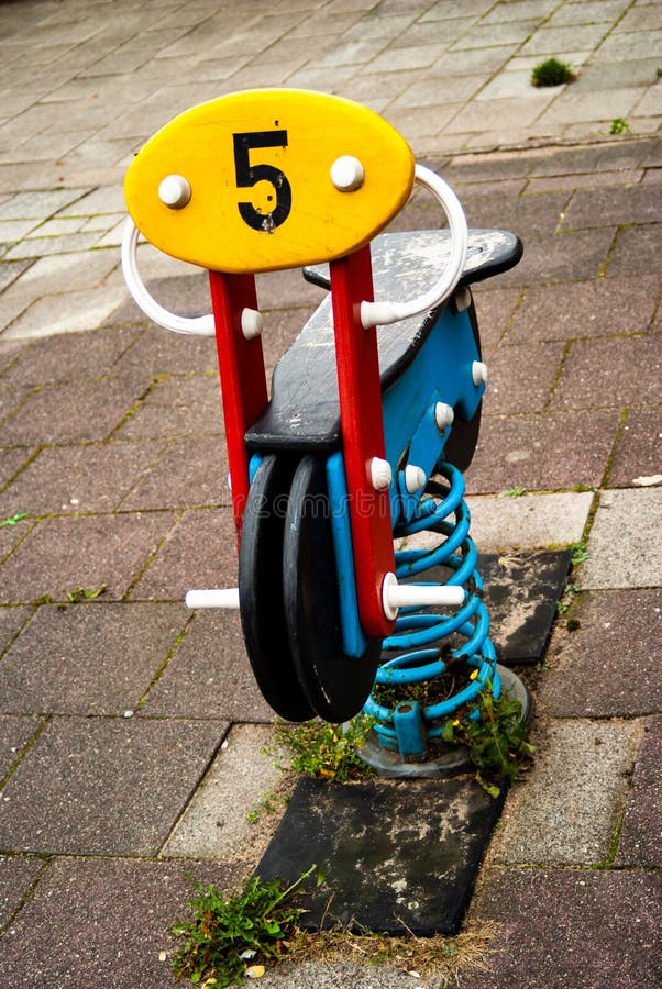 Vertical Shot of a Spring Swing in the Playground Stock Image - Image ...
