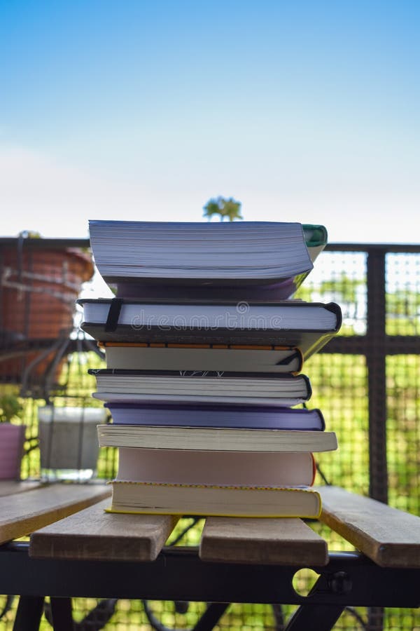 Vertical Shot of a Stack of Books and Notebooks on a Shelf Stock Image ...