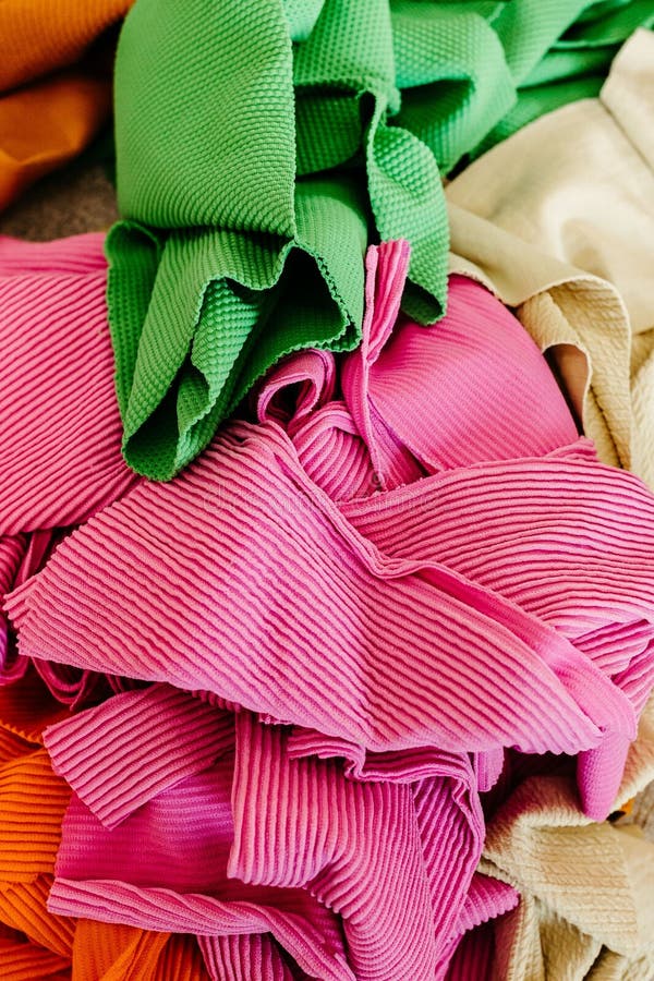 A Vertical Shot of a Stack of Different Fabrics Stock Photo - Image of ...
