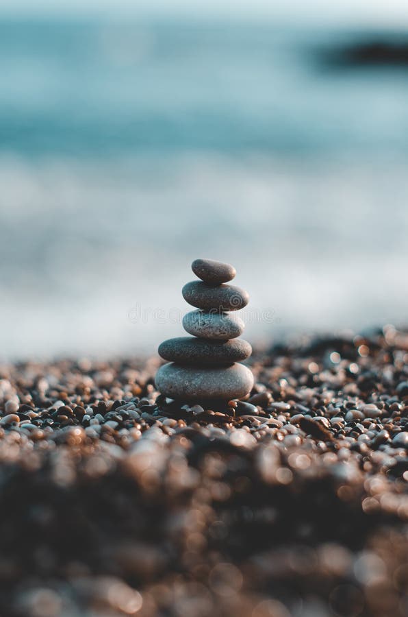 Vertical Shot of a Stack of Pebbles on the Beach Stock Image - Image of ...