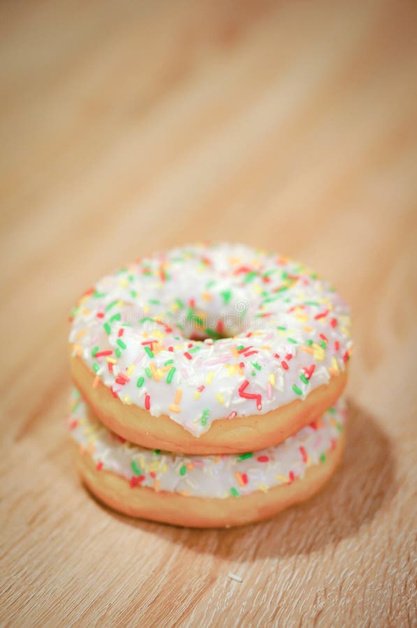 Vertical Shot of a Stack of Sweet Donuts with Vanilla Icing and ...
