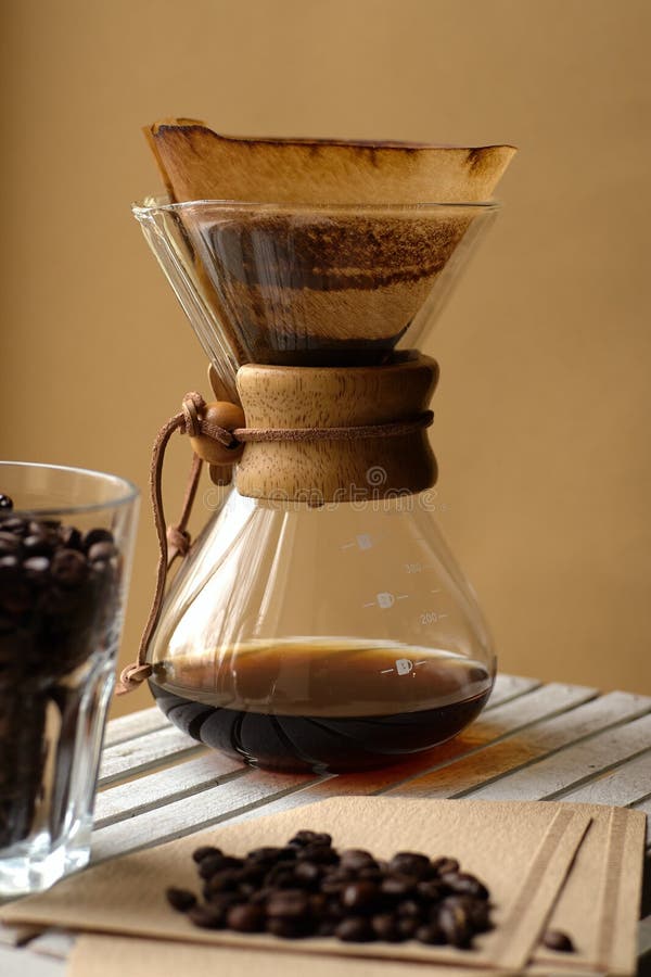 Vertical Shot of a Steaming Coffee Filter and a Glass Cup Filled with ...