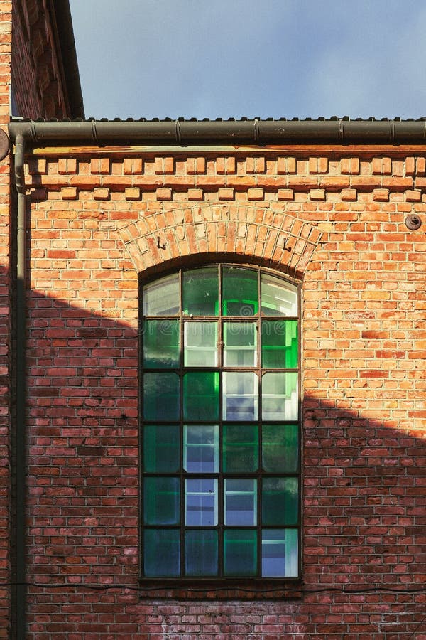 Vertical Shot of a Steel Window on a Red Brick Wall Stock Image - Image ...