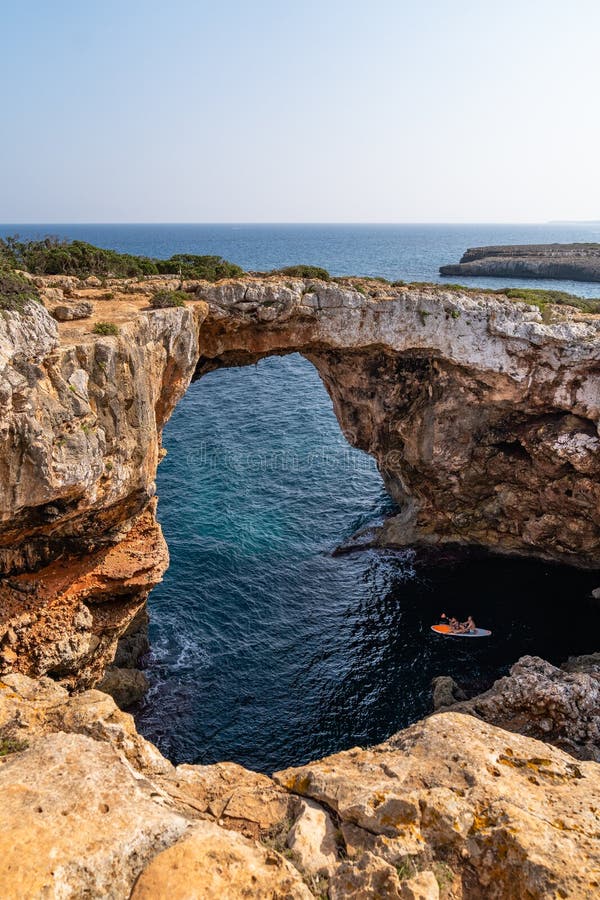 Vertical Shot of a Stone Arch Over Water in Mallorca, Spain Editorial ...